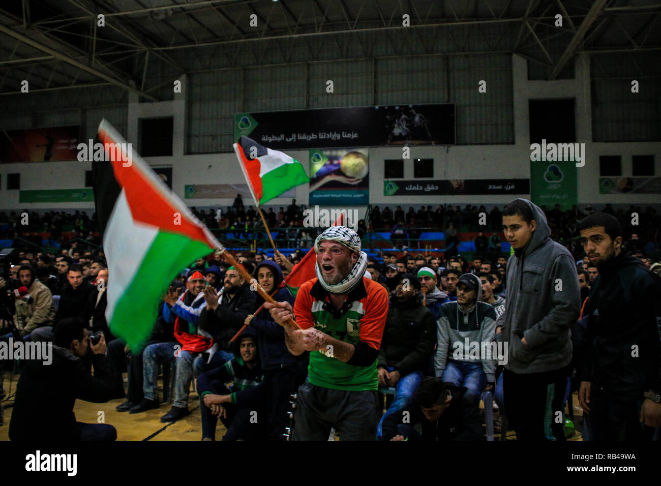 Palestinian fans watch a football match between the teams of Palestine ...