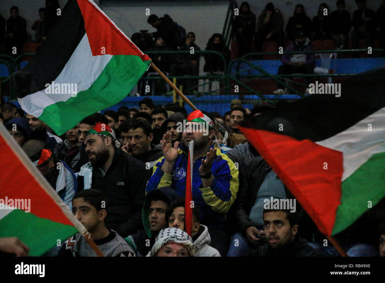 Palestinian fans watch a football match between the teams of Palestine ...
