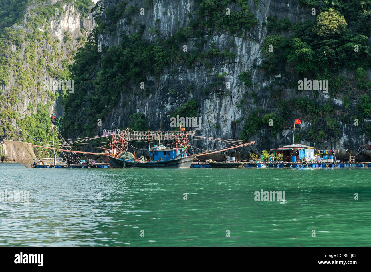 Fishing boats near floating fishing village, Halong Bay Vietnam Stock ...