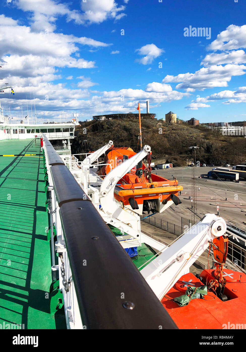 Lifeboats, decks and cabins on the side of cruiseship. Wing of running ...