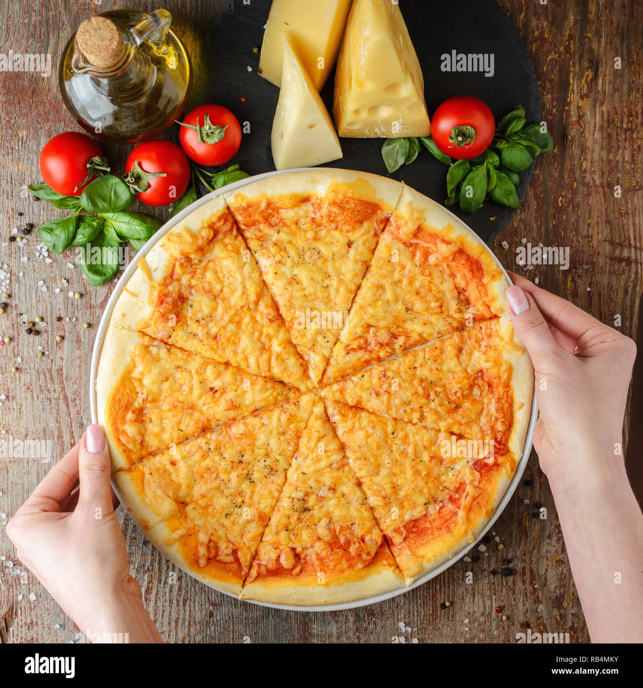 Hands take slices of pizza hi-res stock photography and images - Alamy