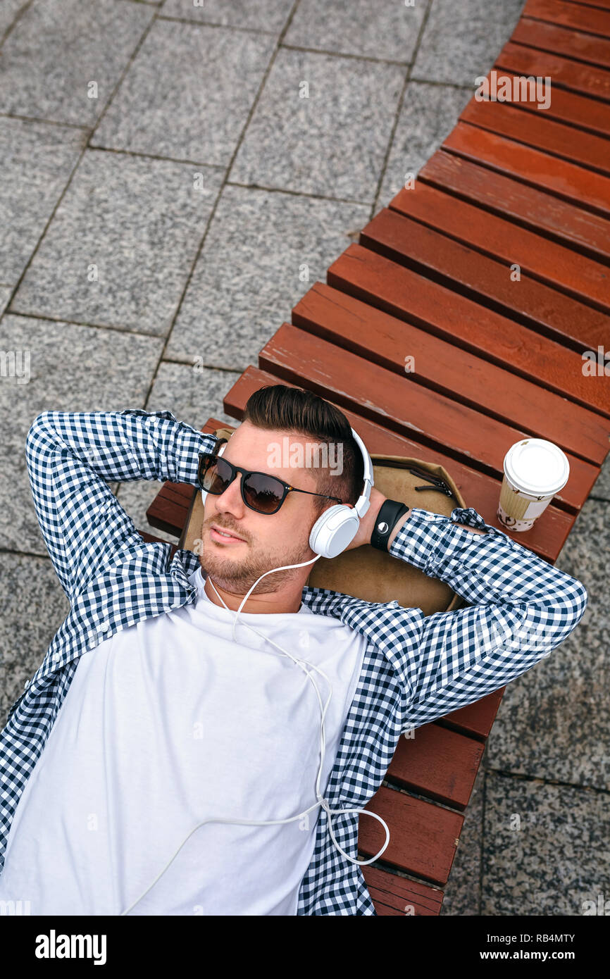 Young man lying on bench hi-res stock photography and images - Alamy
