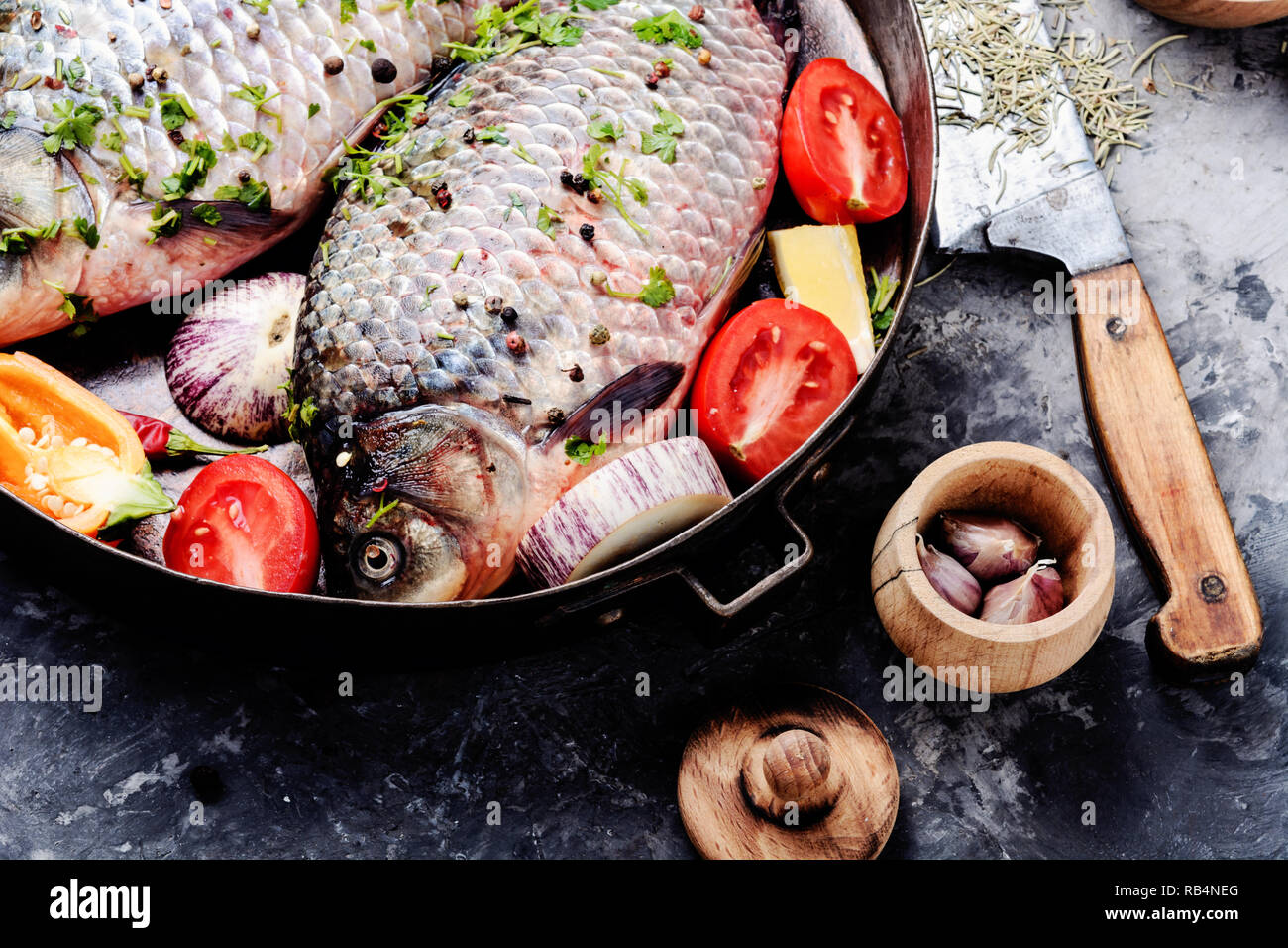Fresh fish carp with ingredients for cooking on pan.Dietary food Stock ...