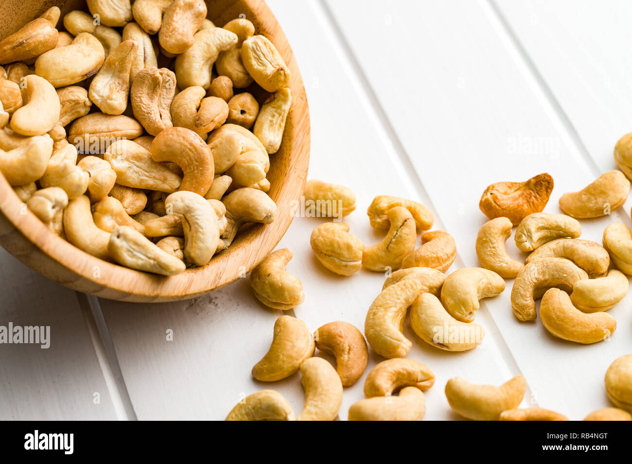 Roasted cashew nuts on white table Stock Photo - Alamy