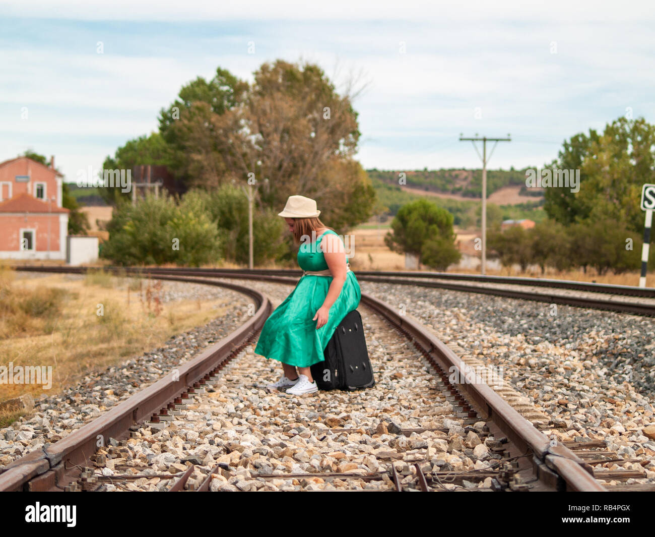 Woman Sitting On Railroad Tracks High Resolution Stock Photography and ...