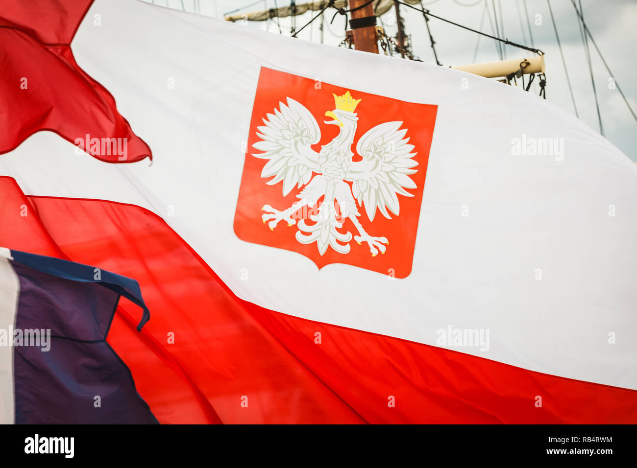 Closeup of polish national flag with eagle emblem on ship in marine ...
