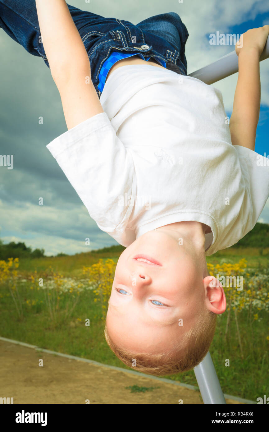 Child hanging upside down on climbing hi-res stock photography and ...