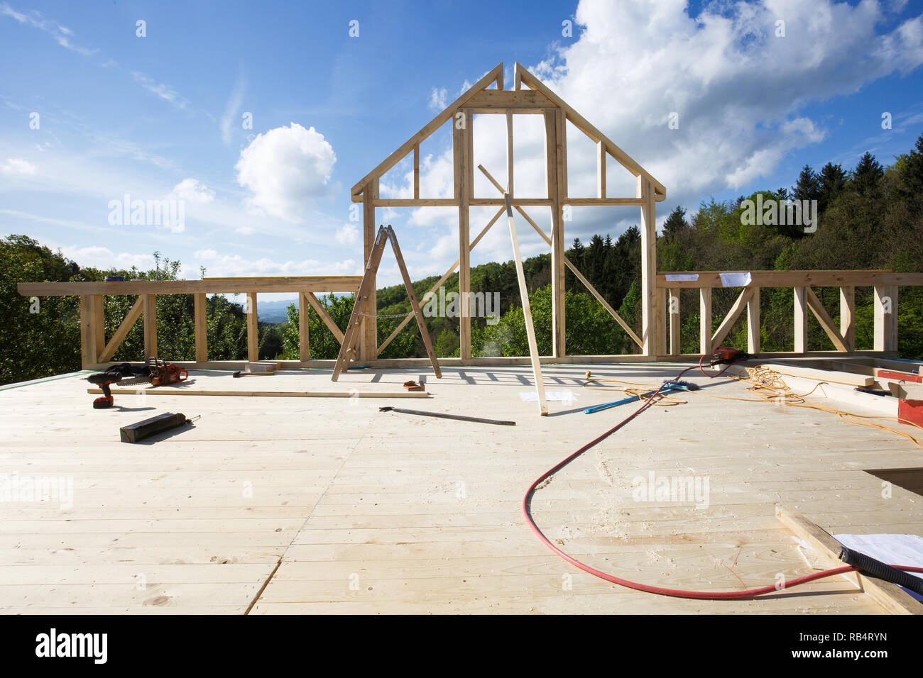 Frame of wooden house under construction, walls being erected. Building ...