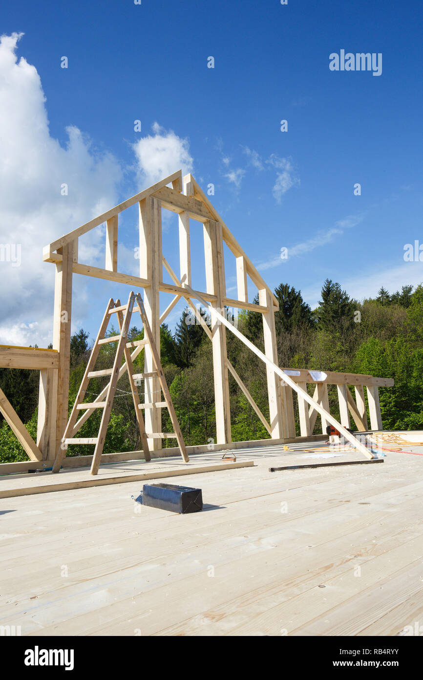 Frame of wooden house under construction, walls being erected. Building ...