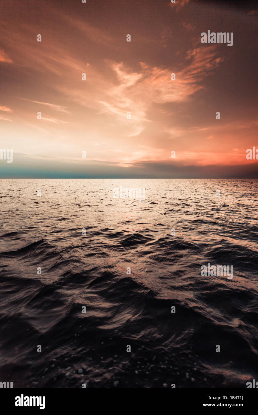 Colorful sunset over evening sea horizon, clouds sky. Tranquil scene ...