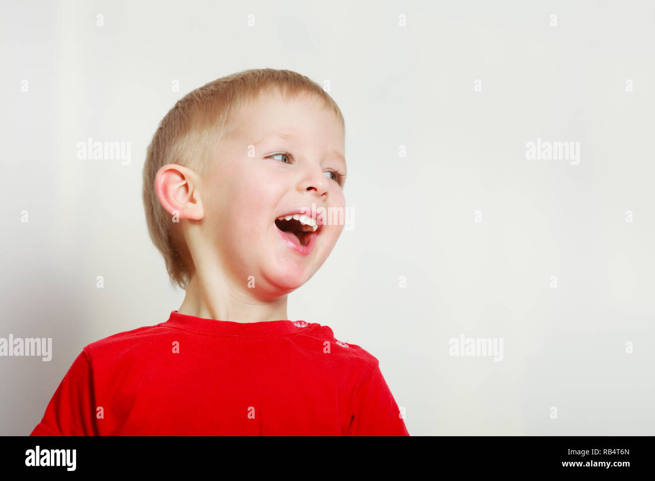 Face expressions, children concept. Portrait of happy kid boy making ...