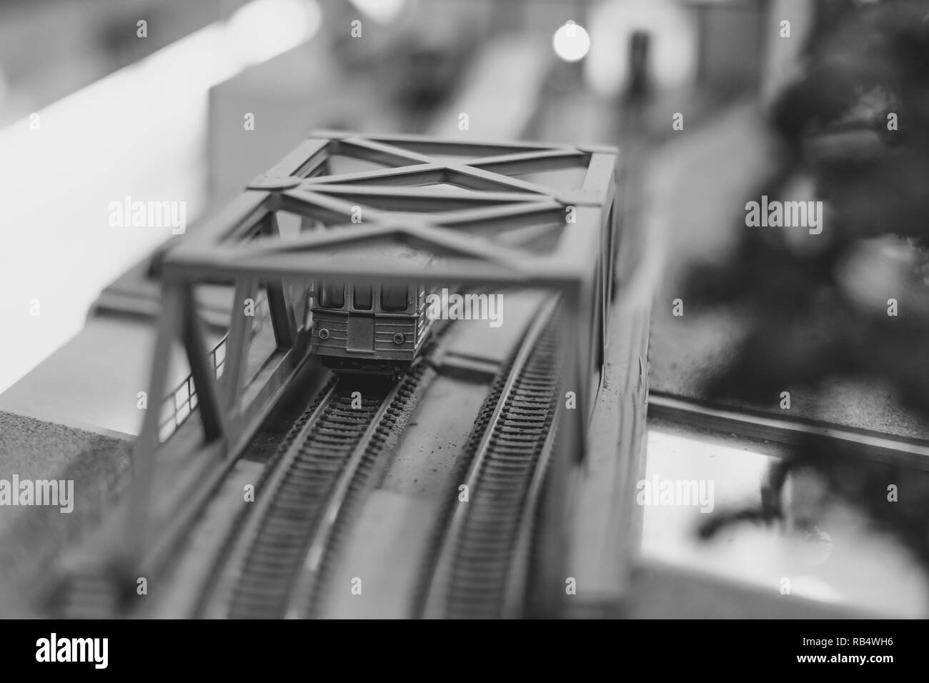 Miniature toy model of modern train crossing bridge Stock Photo - Alamy