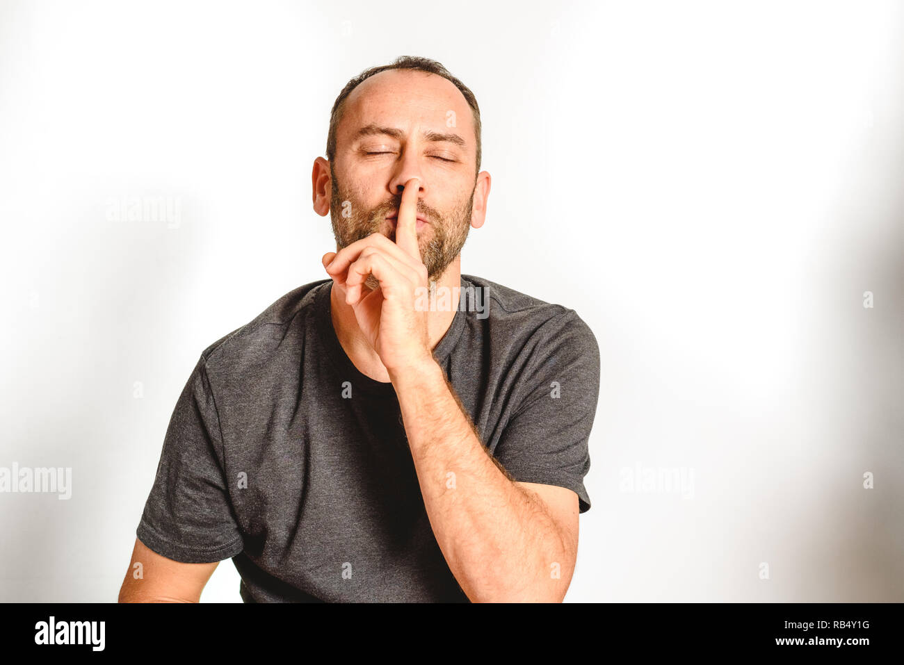 Young man gestures silence putting hi-res stock photography and images ...
