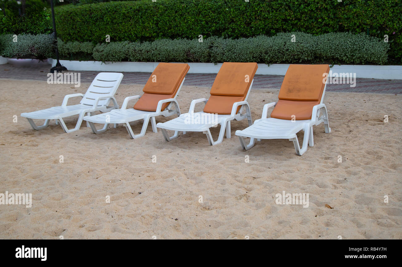 Five white beach chairs on the beach Stock Photo - Alamy