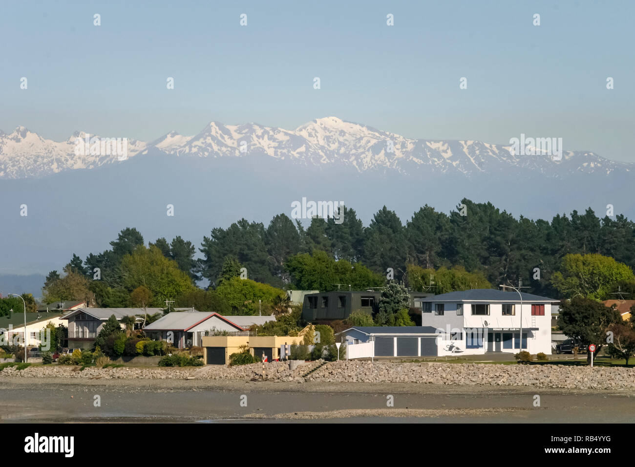 Monaco Boat Club building with the snow capped Kahurangi Mountains in ...