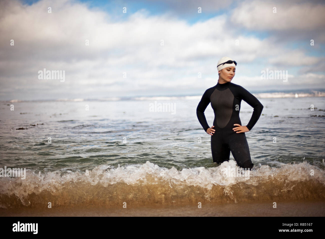 Young female athlete preparing to swim at the beach Stock Photo - Alamy