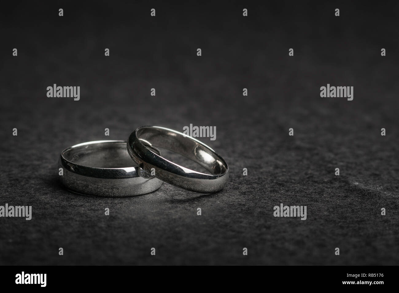 Silver Wedding Rings on a rock background Stock Photo - Alamy