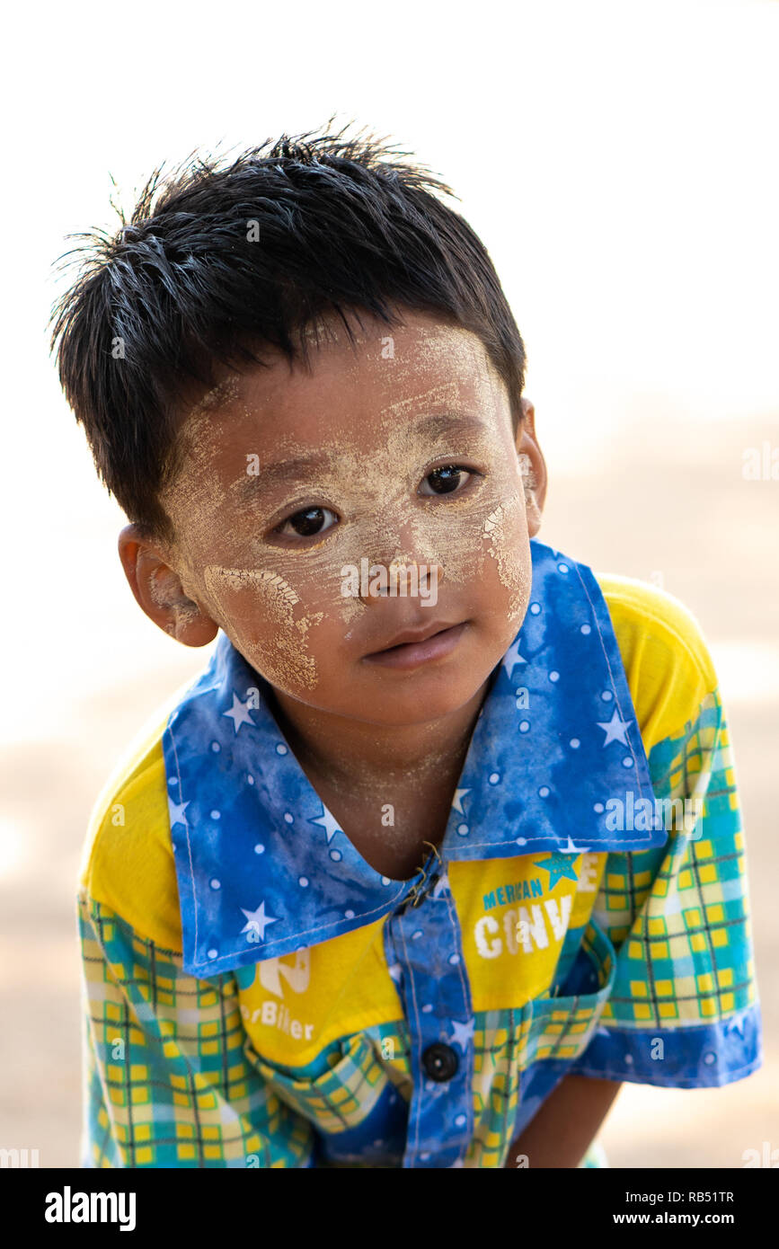 portrait of a Burmese boy with thanaka on his face, Bagan, Myanmar ...