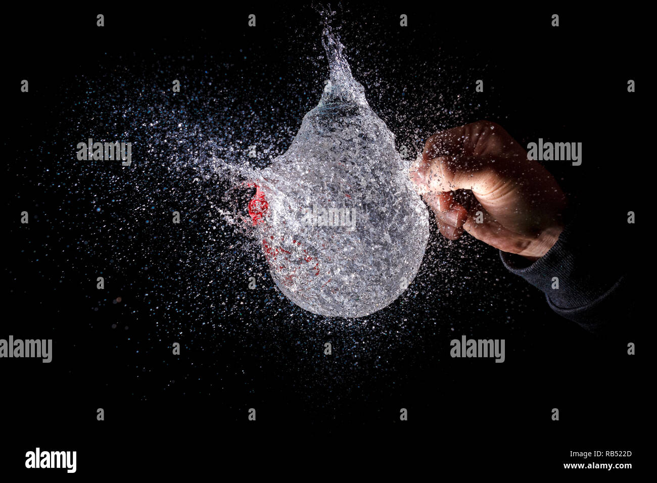 amazing explosion of isolated water balloon on black background with ...