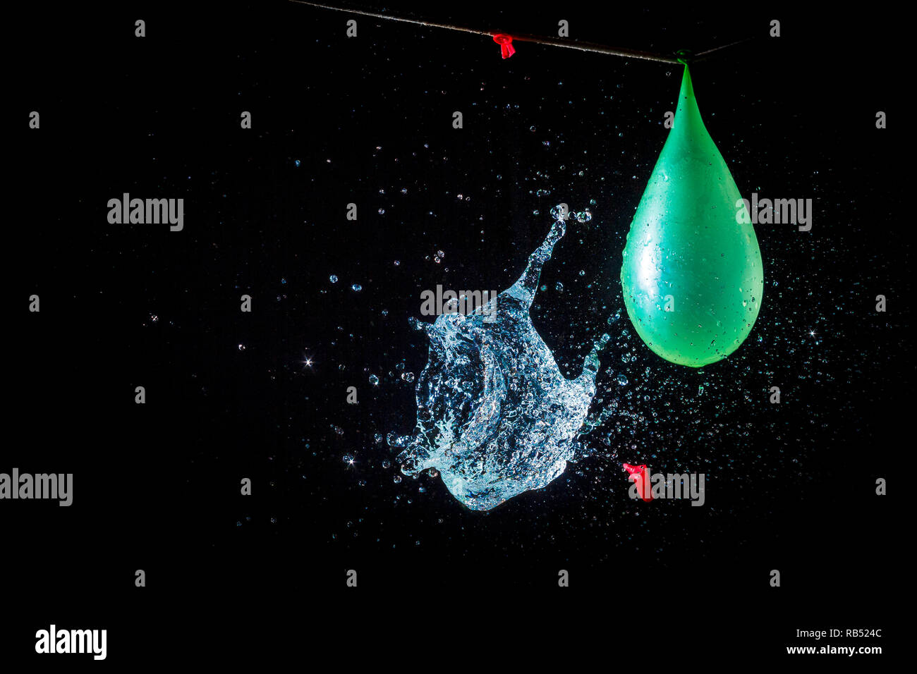 amazing explosion of isolated water balloon on black background with ...