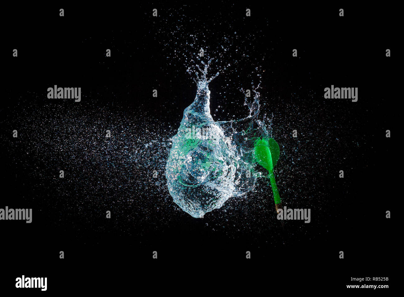 amazing explosion of isolated water balloon on black background with ...