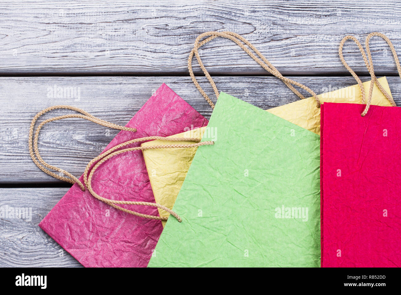 Colorful paper bags for shopping. Group of textured gift bags of ...