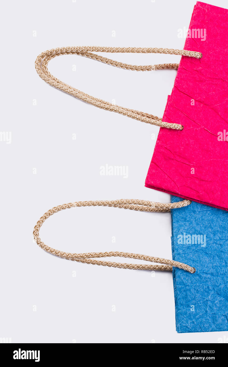 Paper shopping bags with rope handles. Pink and blue crumpled paper ...
