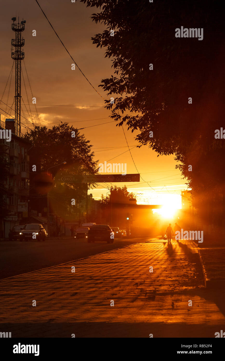 sunset on the city street with pedestrians and cars Stock Photo - Alamy