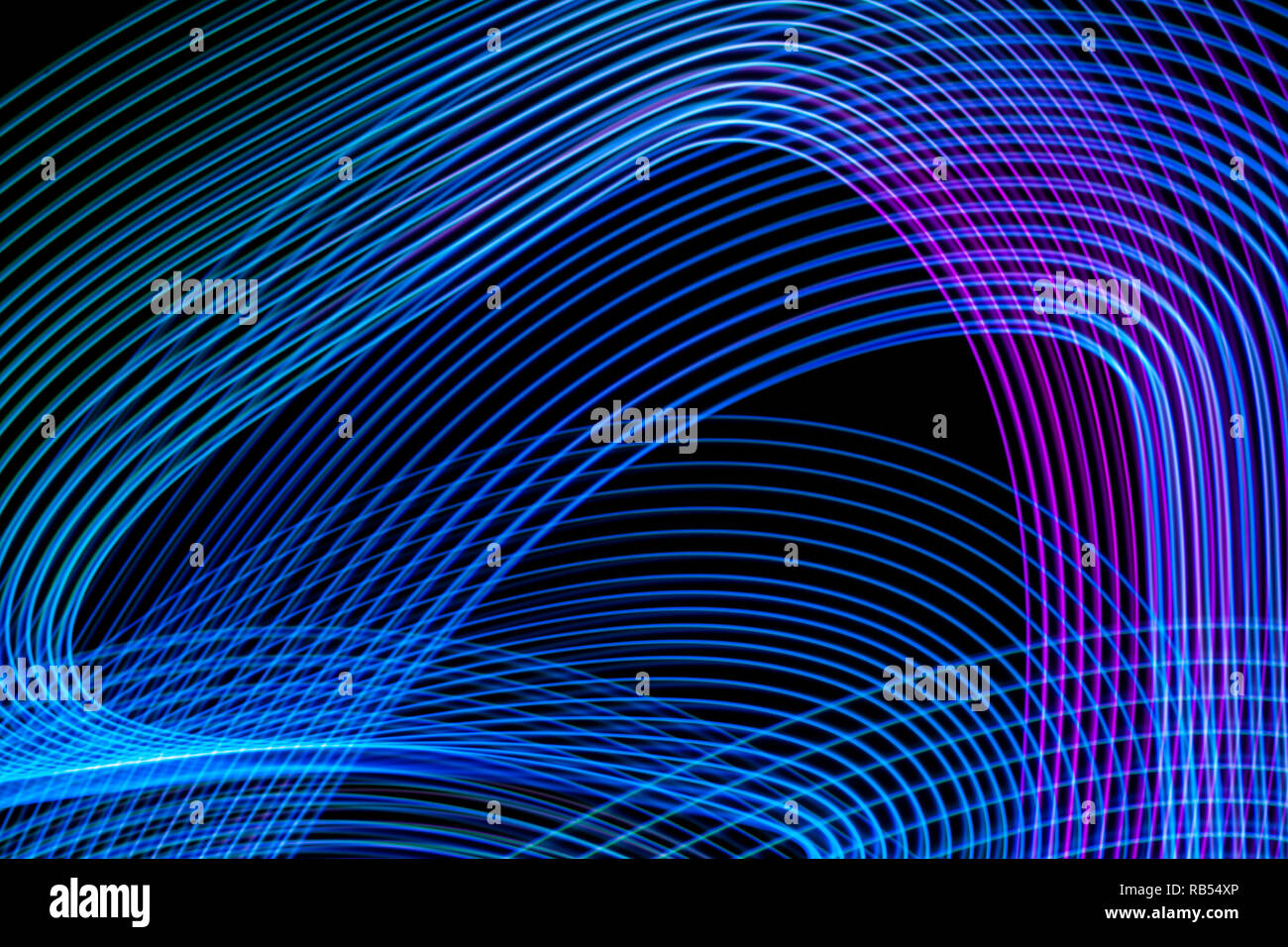 Abstract blue and purple neon glowing crossing lines pattern. Dark ...