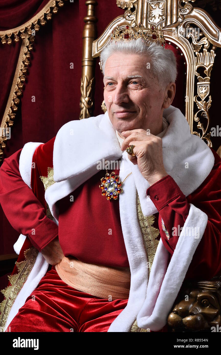 Portrait of confident senior man in red cloak Stock Photo - Alamy