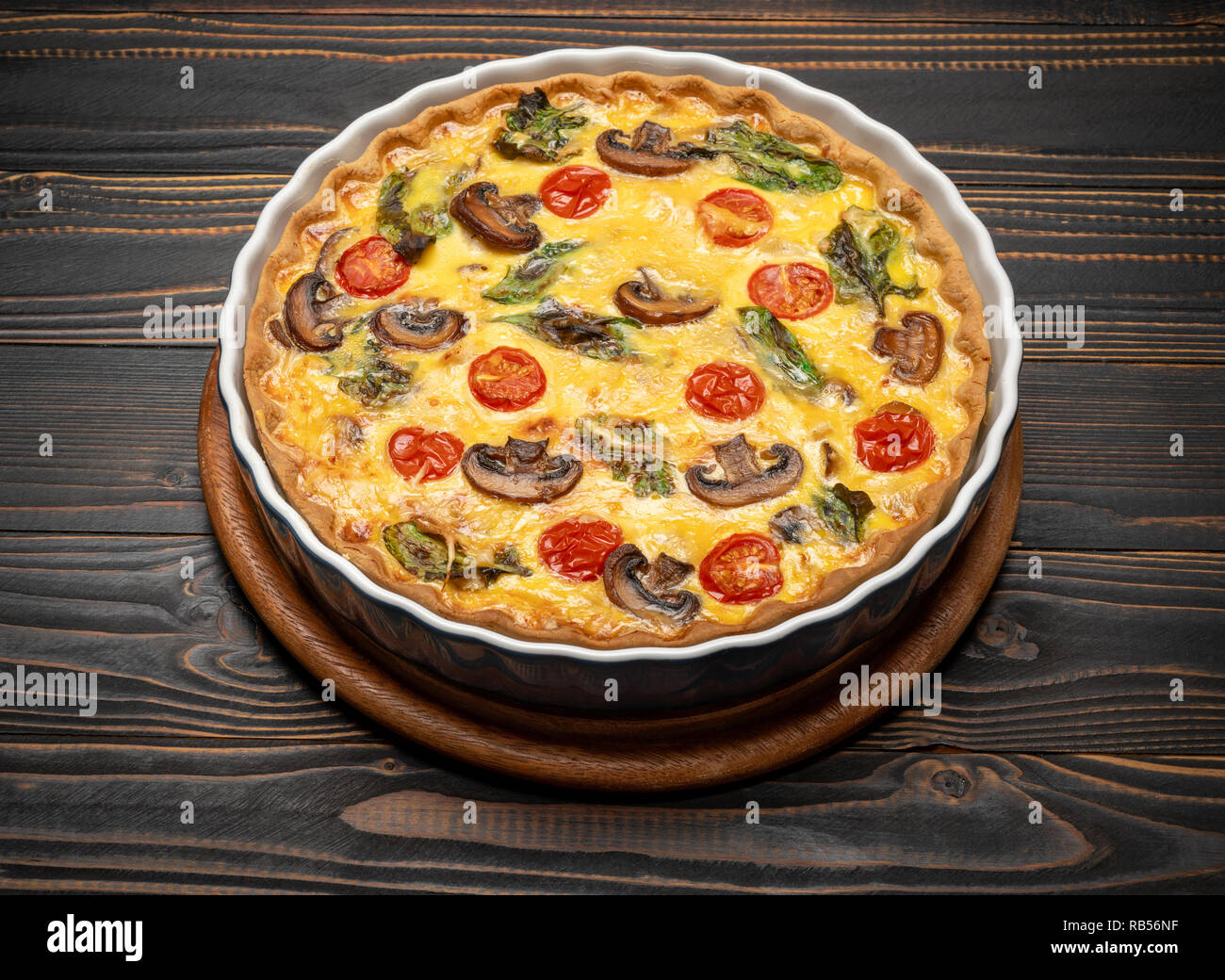 Baked homemade quiche pie in ceramic baking form Stock Photo - Alamy