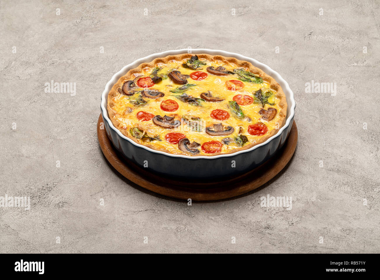 Baked homemade quiche pie in ceramic baking form Stock Photo - Alamy