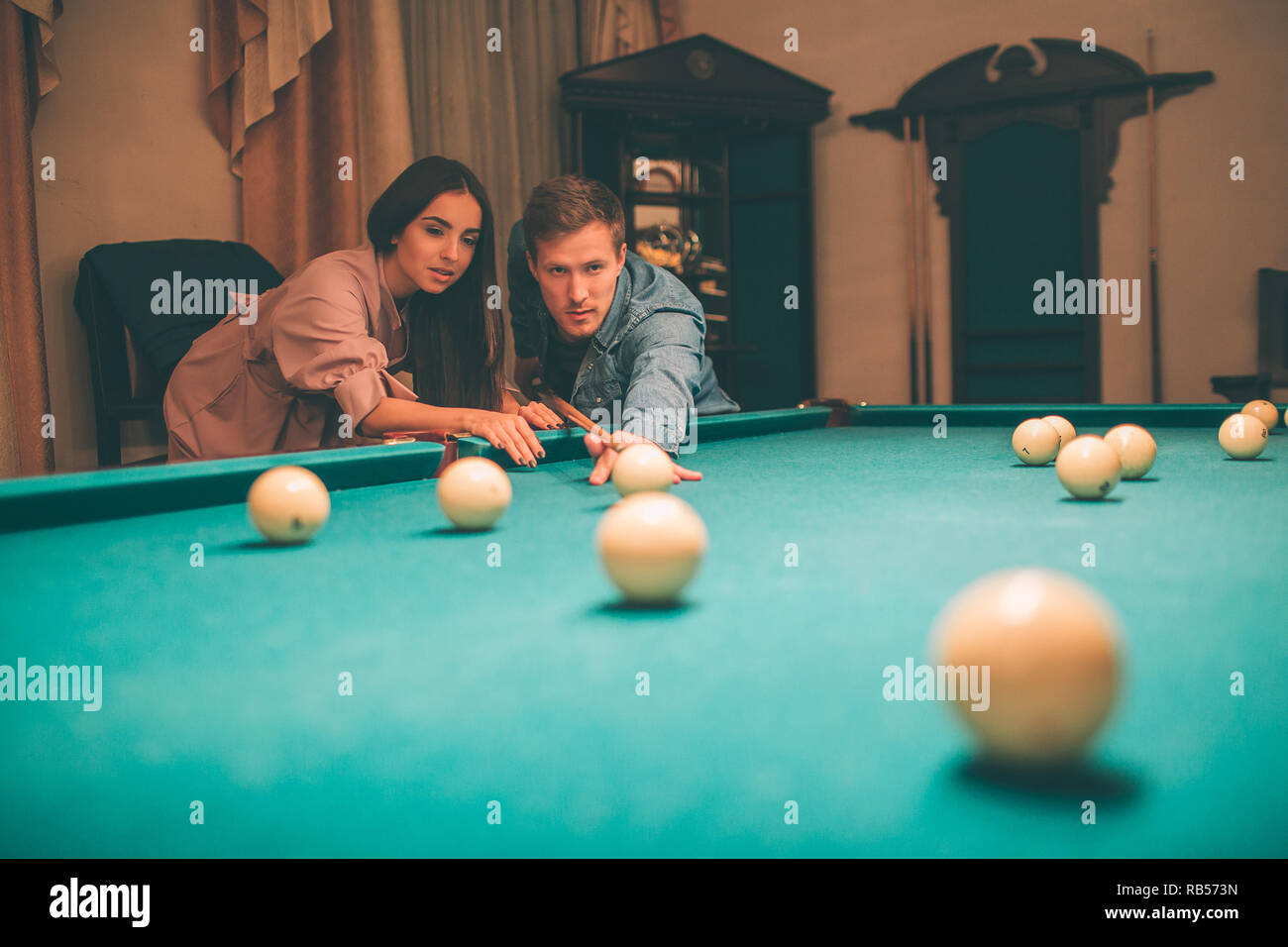 Young player stand in angled position and aiming to break ball. He ...