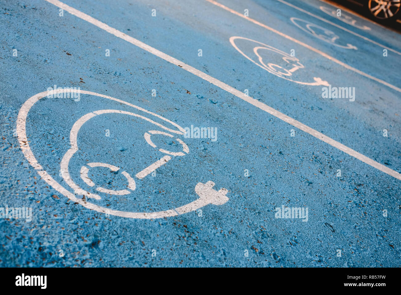 Electric car charging station signal painted on the floor of a car park ...