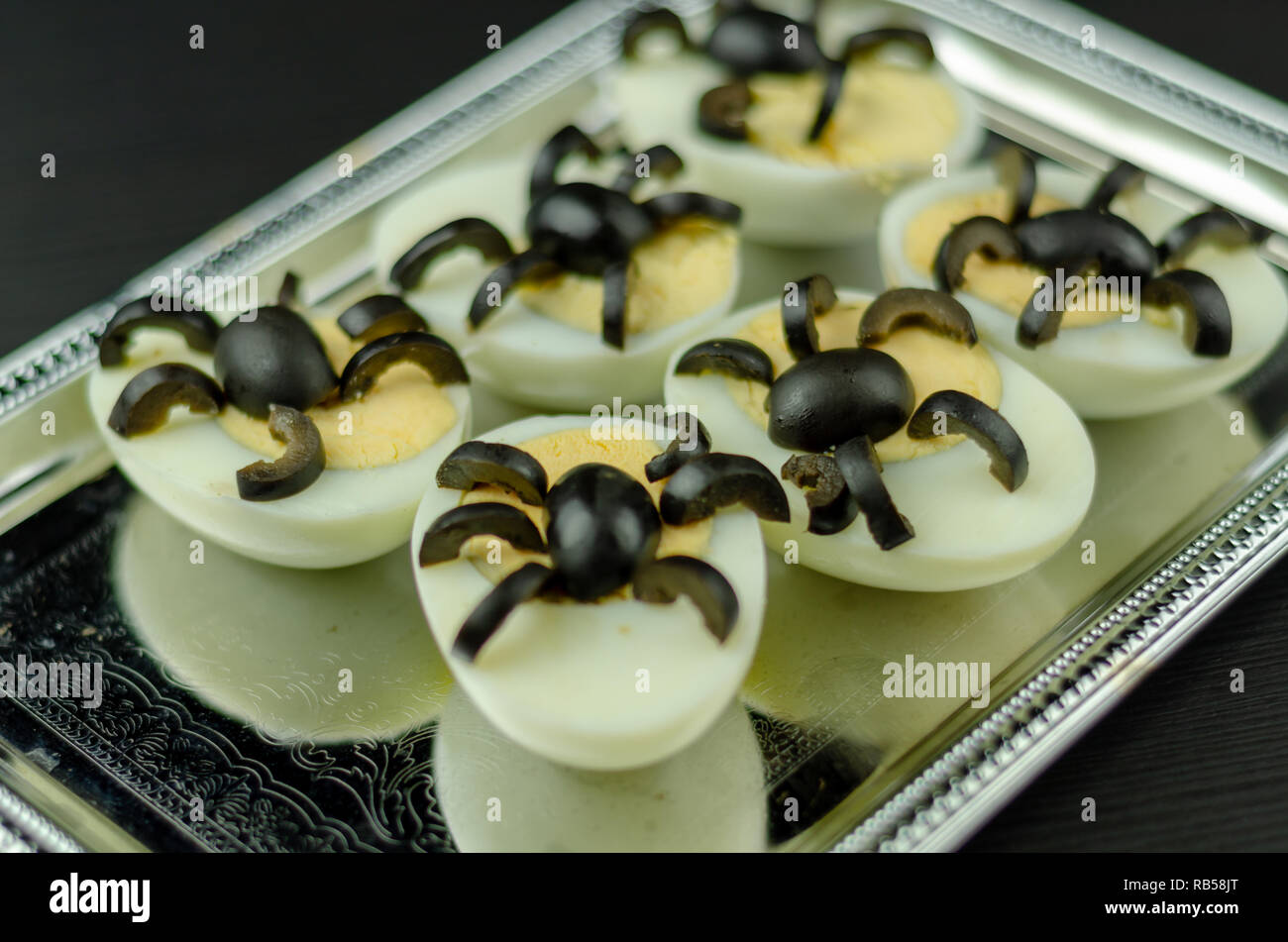 funny snack with olive spiders on egg halves for halloween party ...