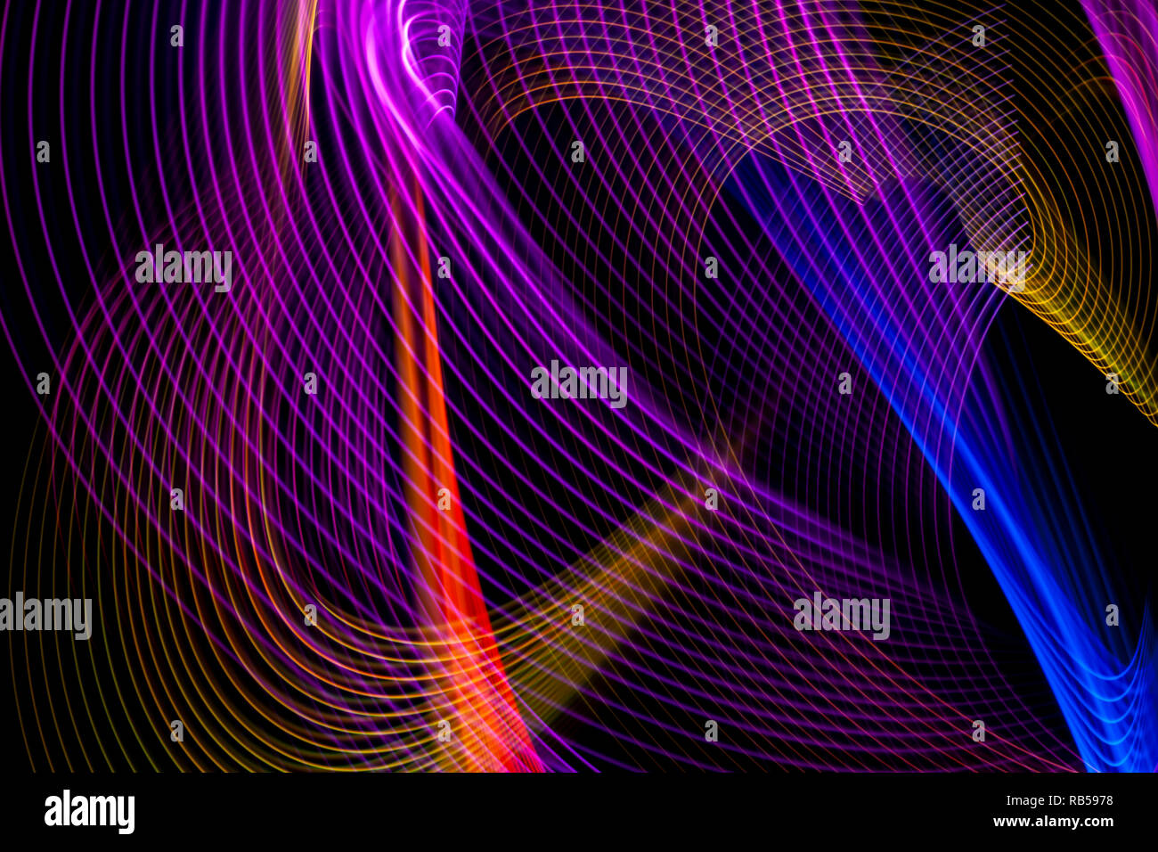 Colorful pink, yellow, green and blue neon spiral lines.Abstract background of blue neon glowing ...
