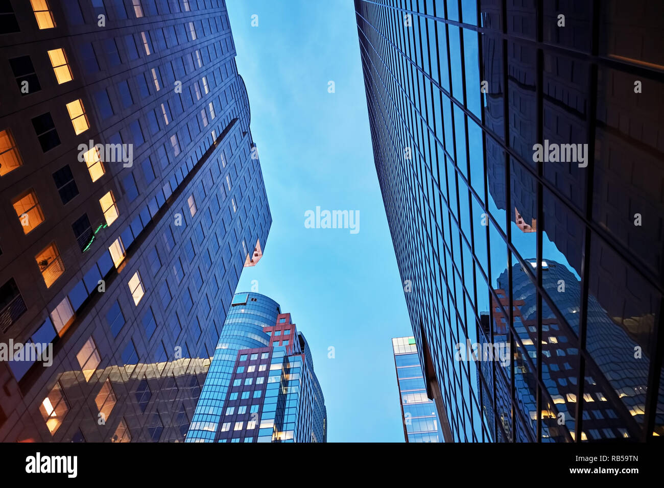 Bottom up view of corporate skyscraper buildings at night in Montreal ...