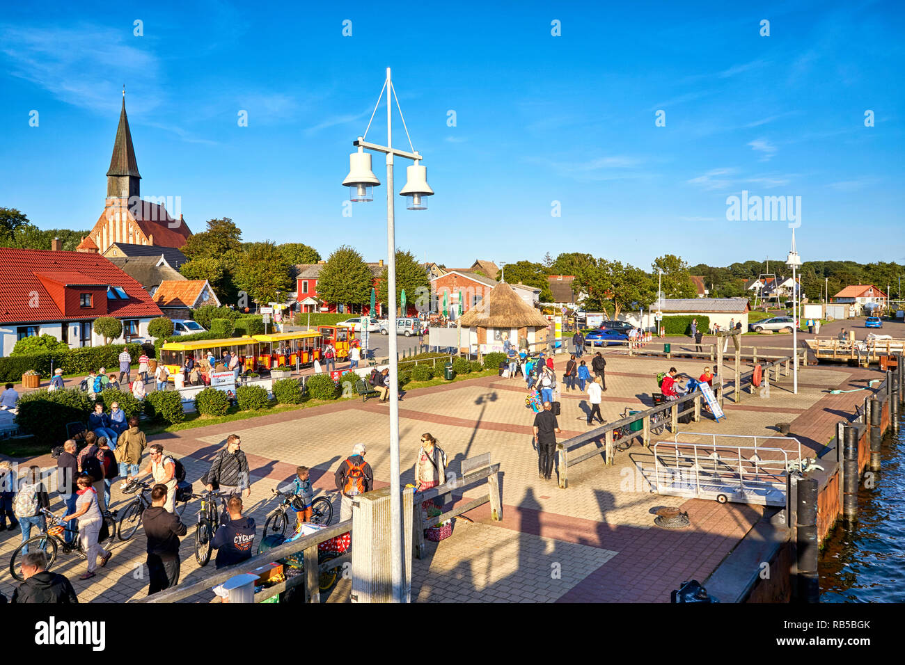 Tourists in the harbor of Schaprode. From here drive the ferryboats to ...