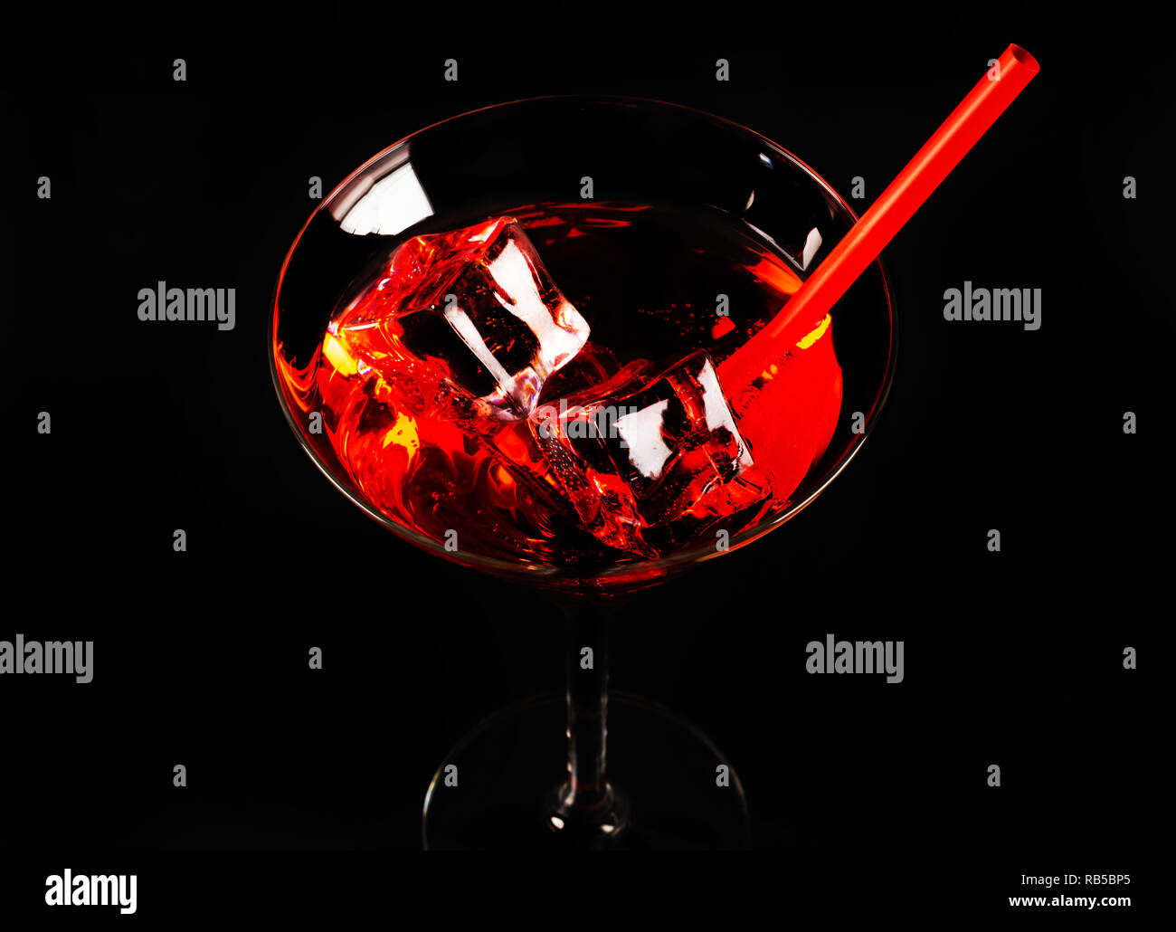 Red refreshing cocktail prepared by the bartender on a black background ...