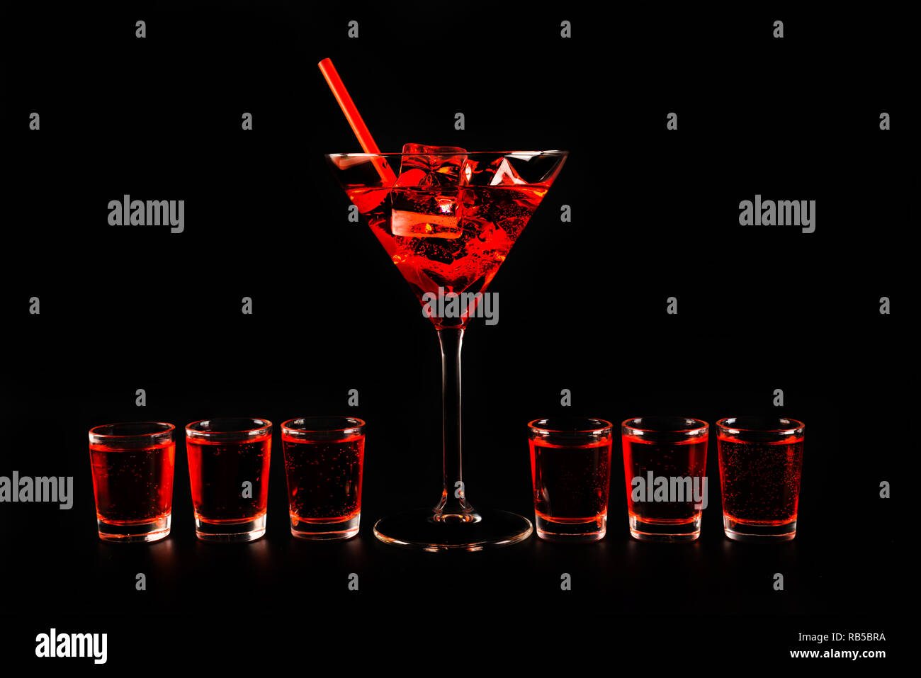 Red refreshing cocktail prepared by the bartender on a black background ...