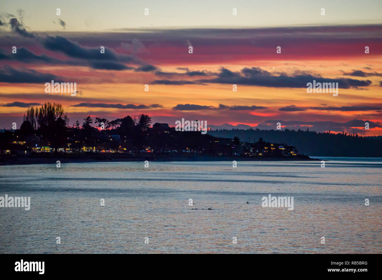 The sky is rich with colors as the sun set at Alki Beach in West ...