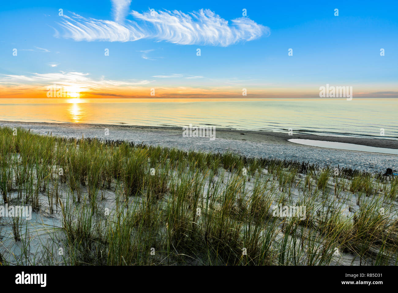 Sandy beach and sunset sky with golden sun shining on white sand Stock ...