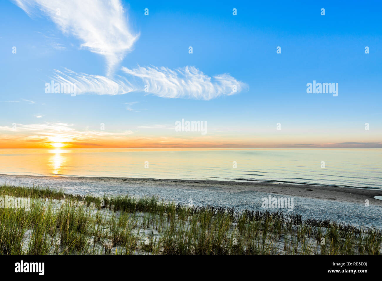 Sandy beach and sunset sky with golden sun shining on white sand Stock ...