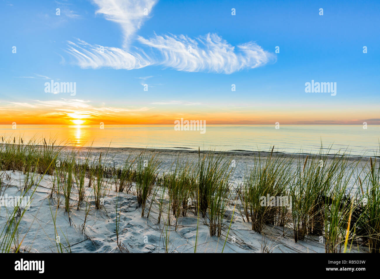 Sandy beach and sunset sky with golden sun shining on white sand Stock ...