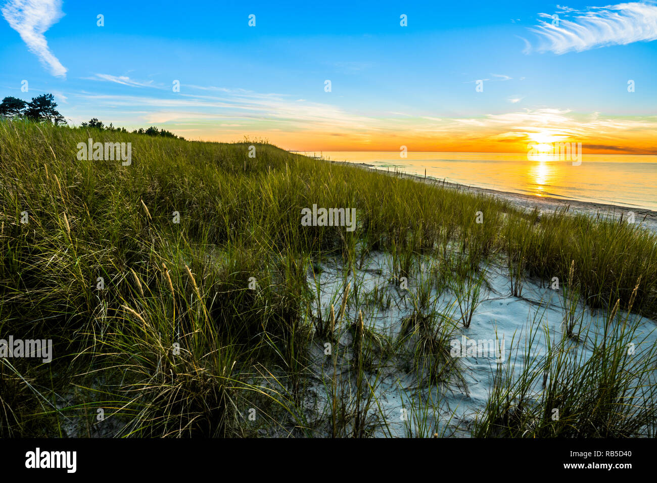 Sandy beach and sunset sky with golden sun shining on white sand Stock ...