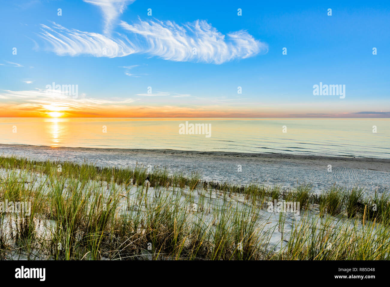 Sandy beach and sunset sky with golden sun shining on white sand Stock ...