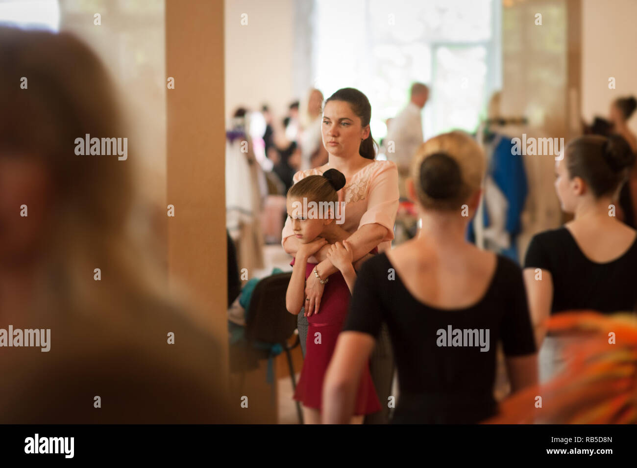 young beautiful mother embracing her little ballerina dancer girl ...