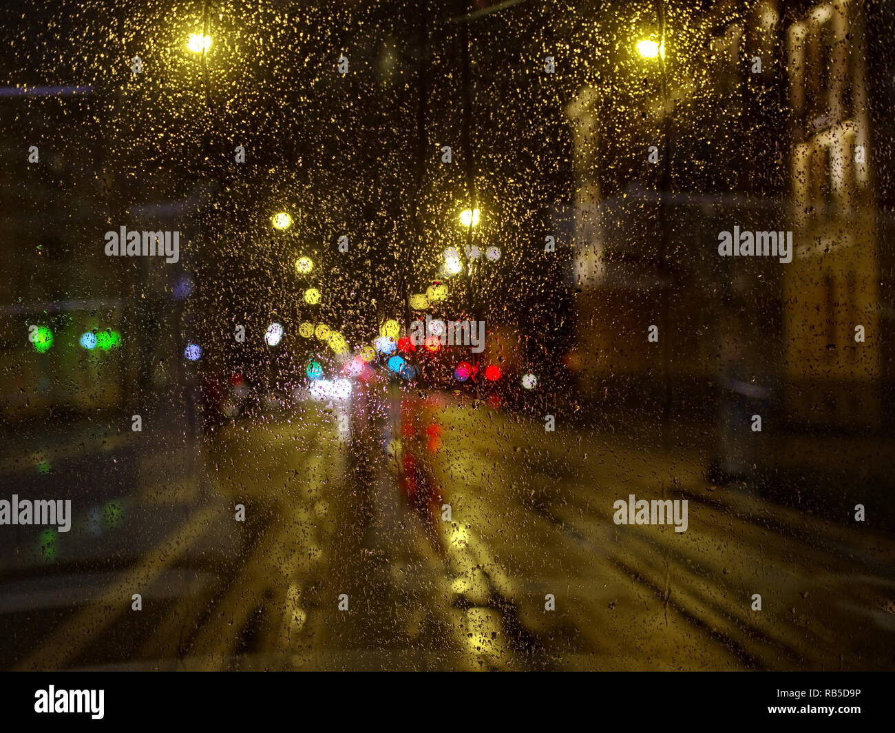 Rainy night from tram windows defocused road view Stock Photo - Alamy