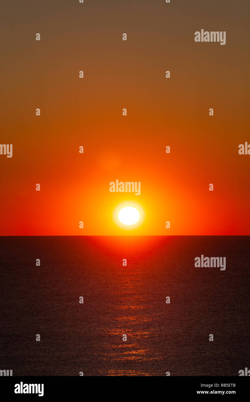 Golden sunset centered over a calm sea in Newquay, Cornwall, UK Stock ...