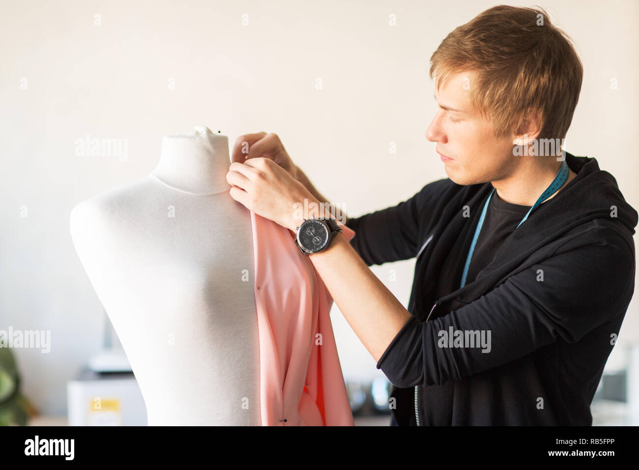 fashion designer with dummy making dress at studio Stock Photo - Alamy